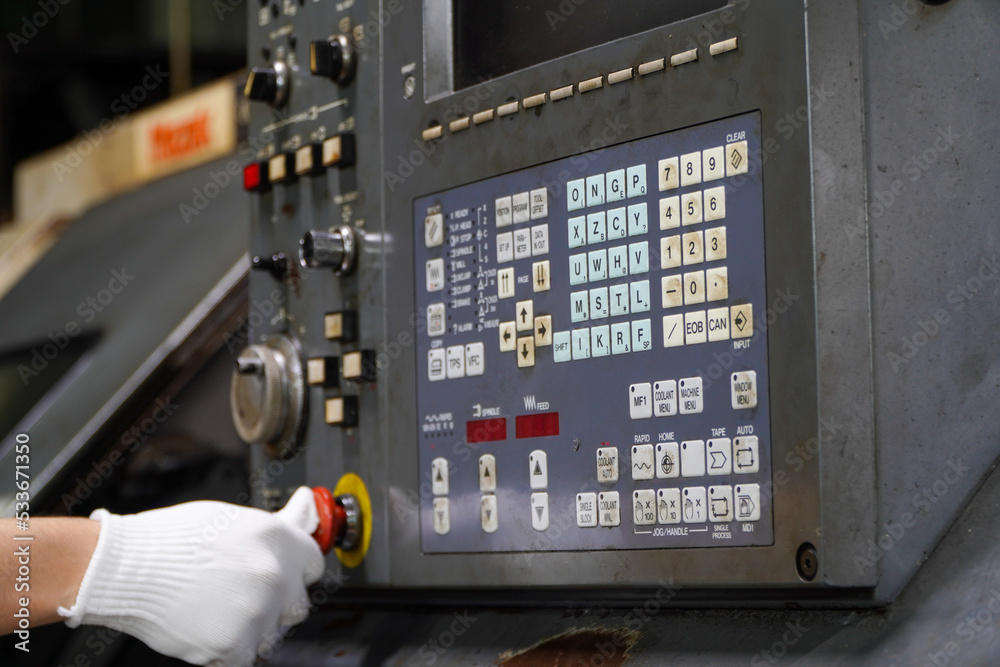 Press the emergency button on cnc machine control panel at factory ...