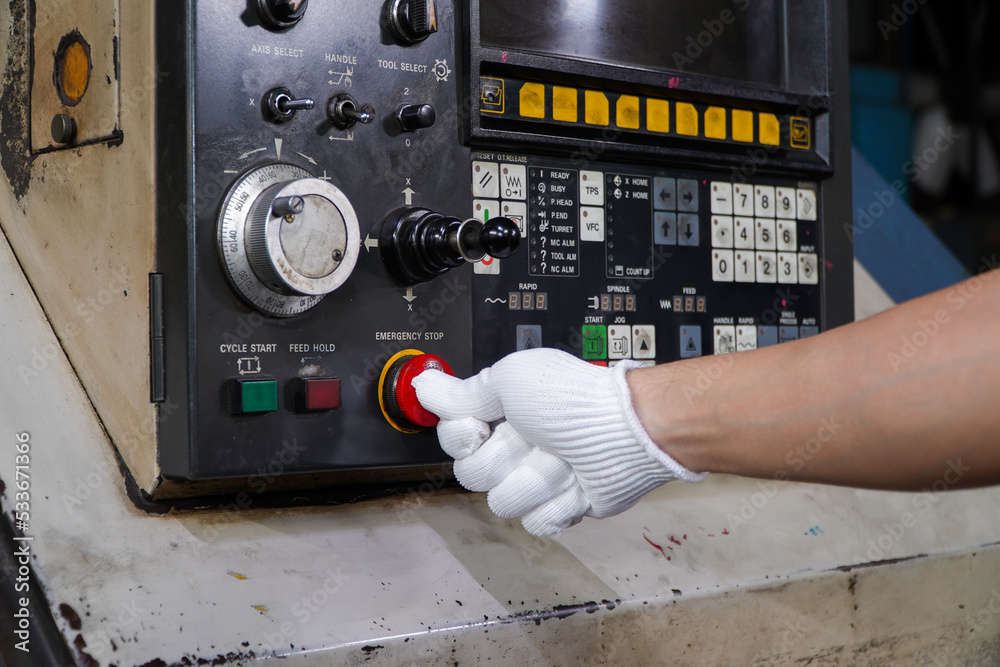 Press the emergency button on cnc machine control panel at factory ...
