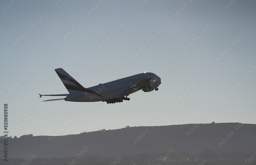 Silhouette of Emirates Airways Boeing double decker 787 airplane taking ...
