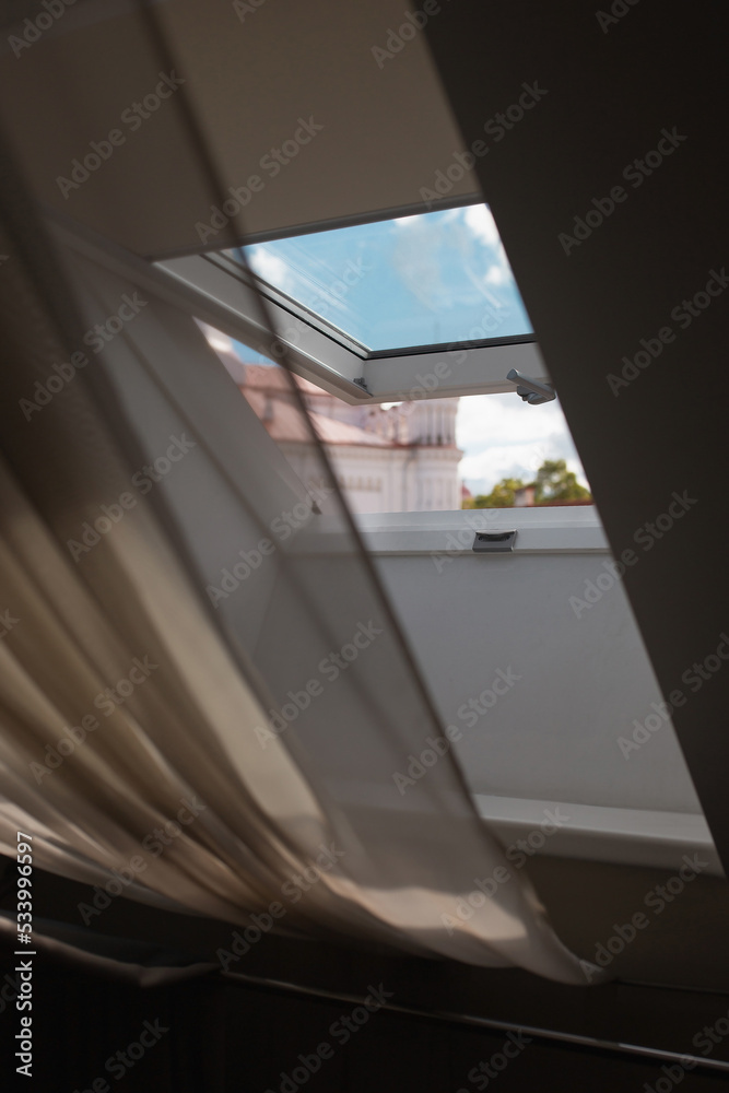 Attic window with sloping roof - daylight inside the room - hotel room ...
