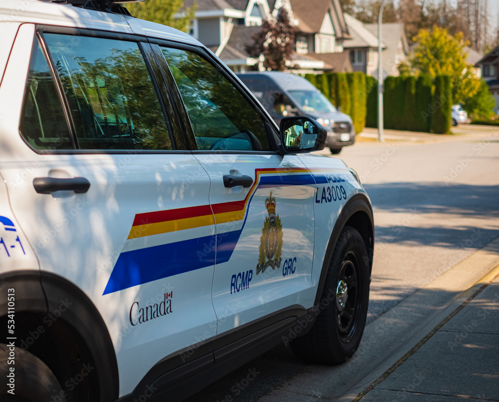 RCMP vehicle stopped on a street. The door logo crest of a white Royal ...