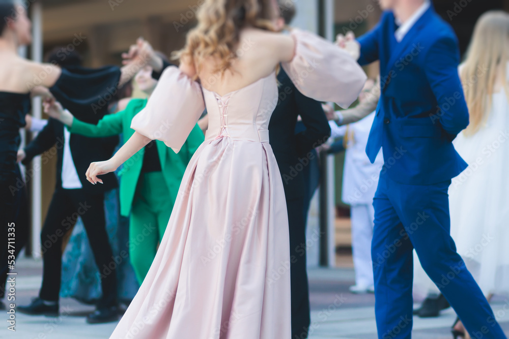 High school graduates dancing waltz and classical ball dance in dresses ...