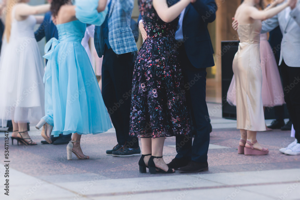 High school graduates dancing waltz and classical ball dance in dresses ...