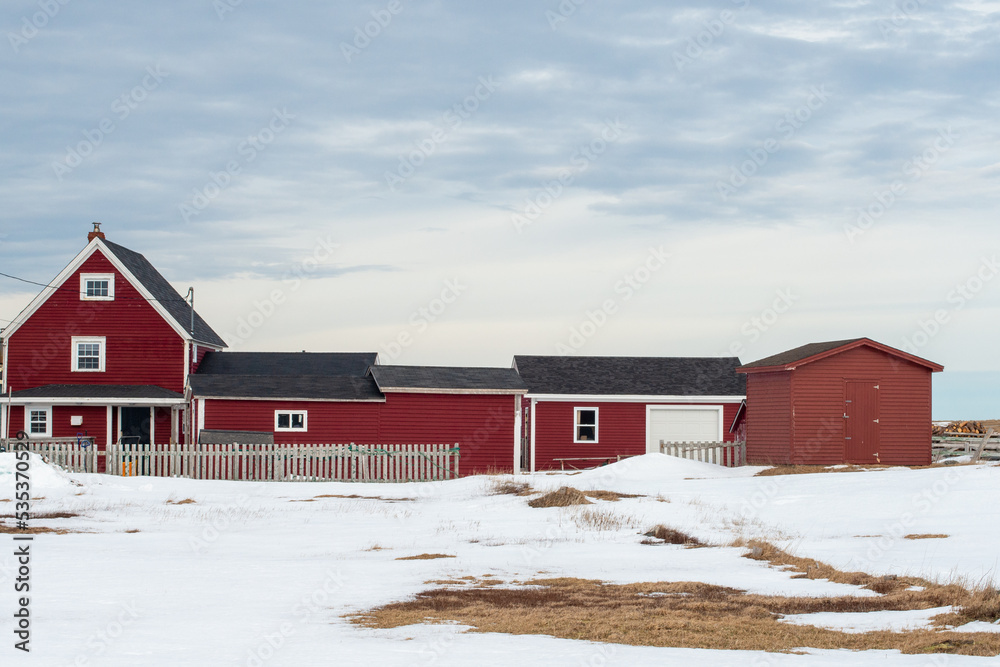 A red farm house with multiple additions and outcrop buildings with a ...