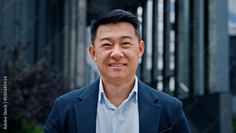 Close up front view in city outdoors Asian Korean man business boss ...
