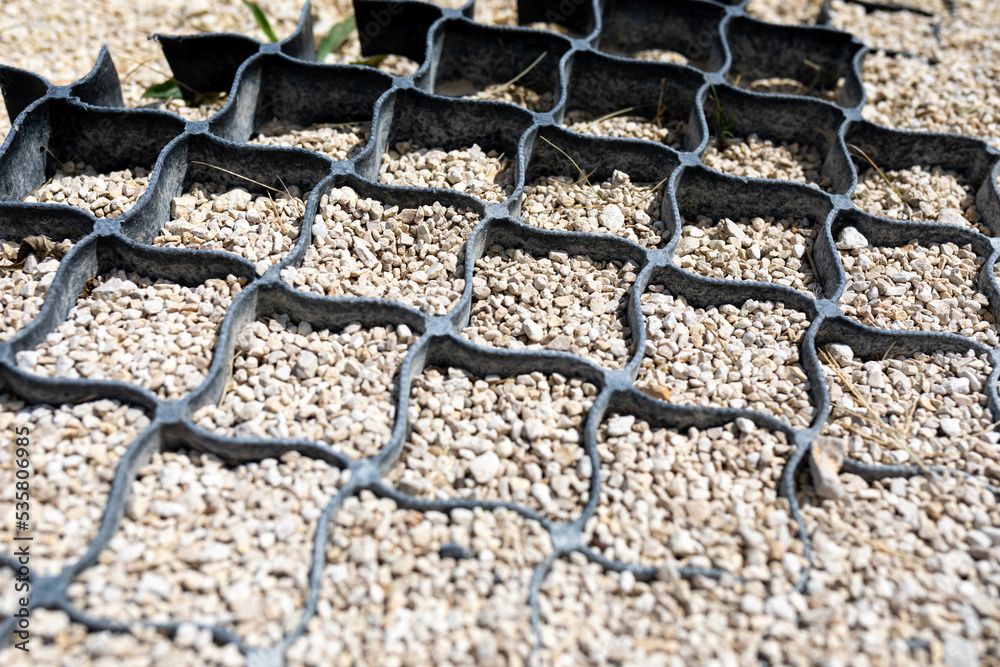 Cellular retention system is a plastic black frame filled with fine ...