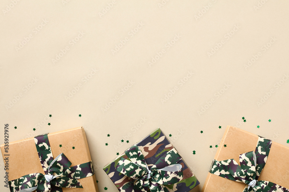 Military gift boxes and confetti stars on beige background. Presents ...
