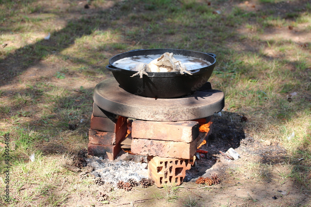 Chicken in the cauldron before plucking feathers. Heat treatment ...