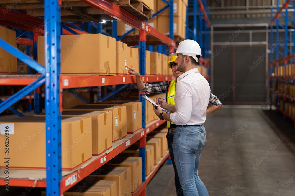 Supervisor and manager smiling happy holding laptop computer on hand ...