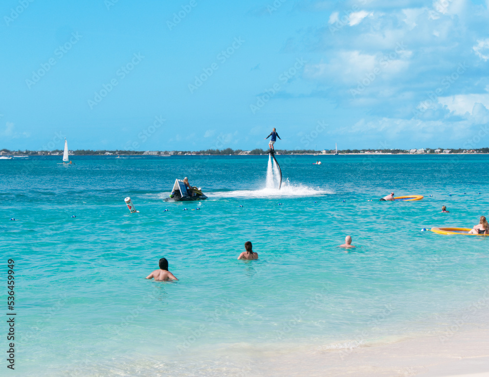 Recreational beach ocean sea activity with jet pack hovering with ...