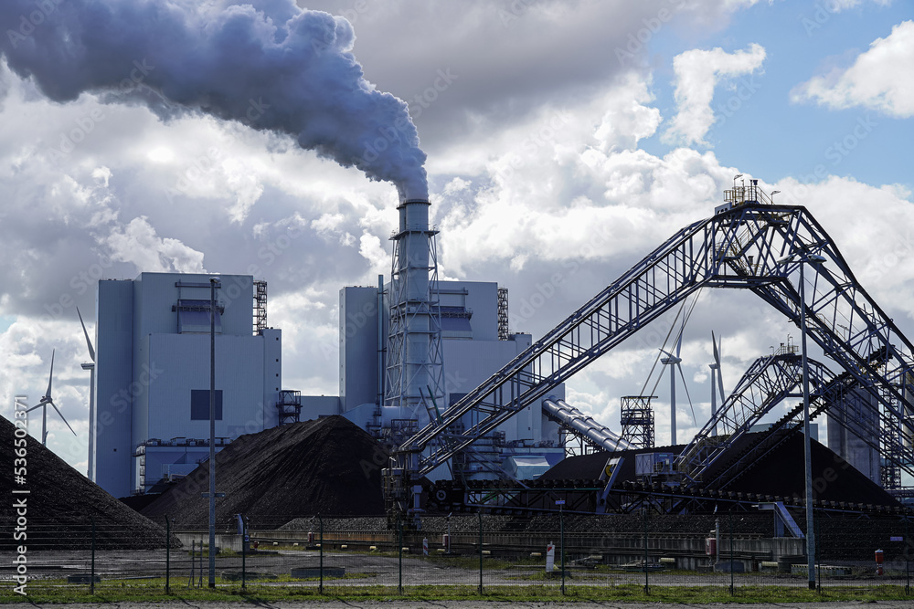 Fossil fuel (coal) power station and wind turbines in the Eemshaven ...