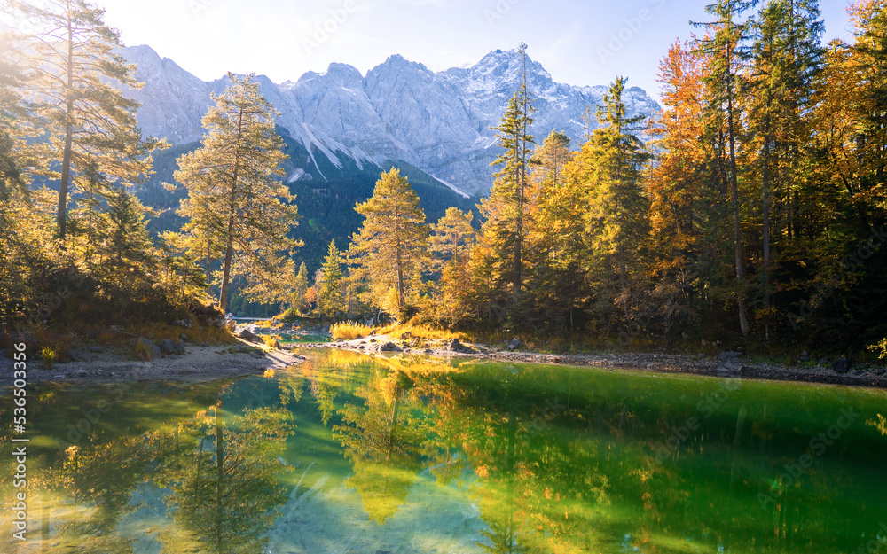 Autumn colors in fall at lake Eibsee. Alpine landscape with German Alps ...