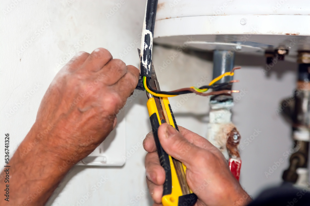 Electrical wires are dangerous. An electrician replaces electrical ...