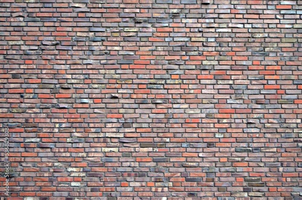 Colorful wide brick wall background with small red and grey bricks ...