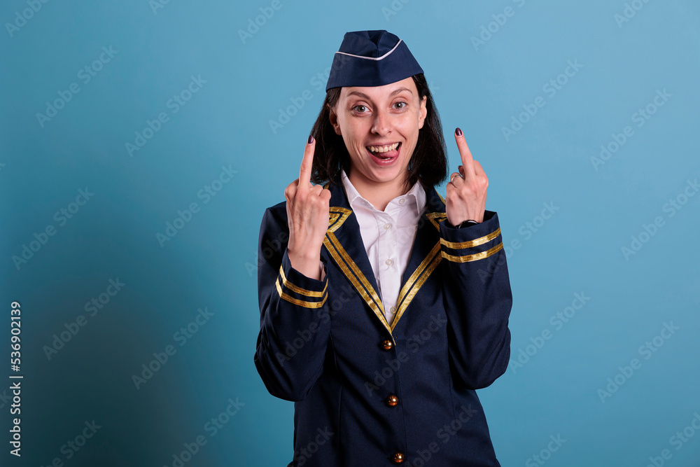 Стокове фото Smiling airplane flight attendant showing middle finger ...