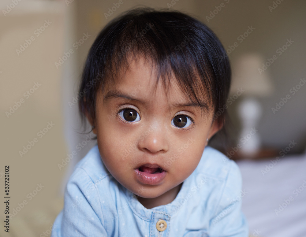Face, down syndrome baby and bedroom portrait in home alone, looking ...