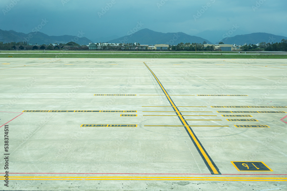 Airport runway ground with direction line and symbol guideline for ...
