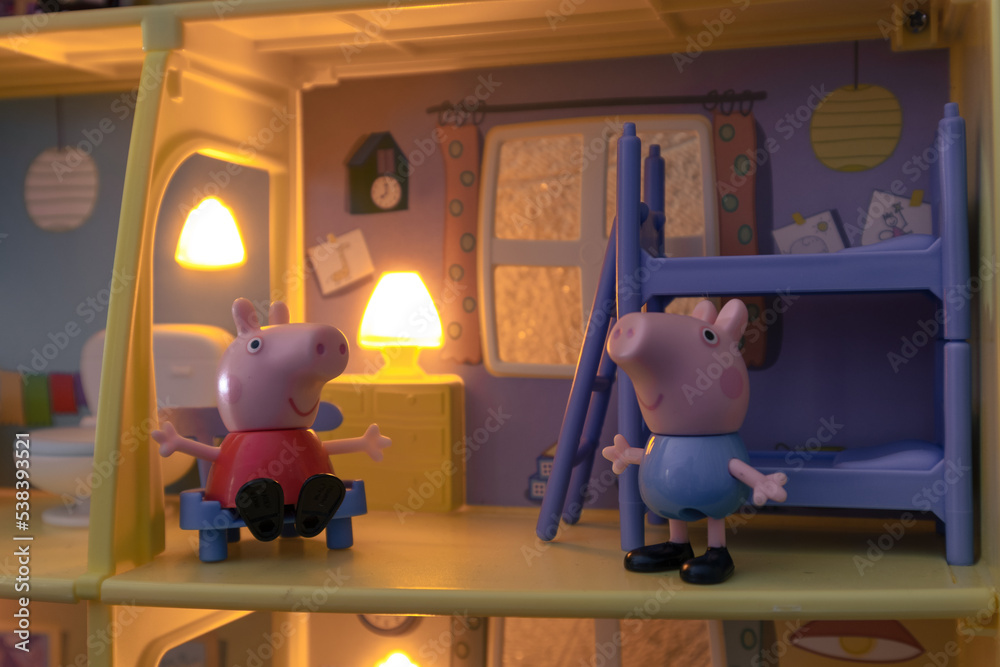 Peppa Pig's toy house. Peppa Pig and little George are sitting in the ...