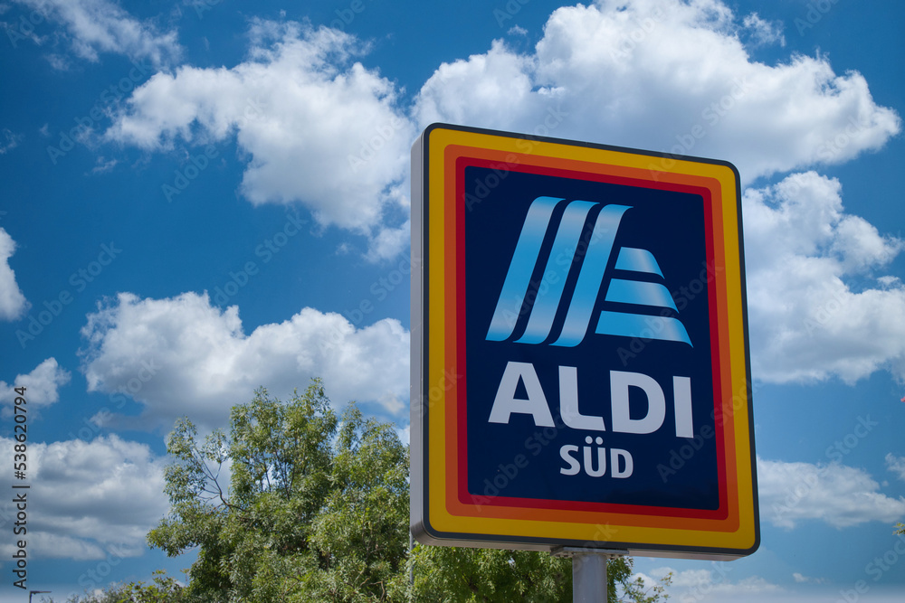 aldi sign with blue sky and clouds Stock Photo | Adobe Stock