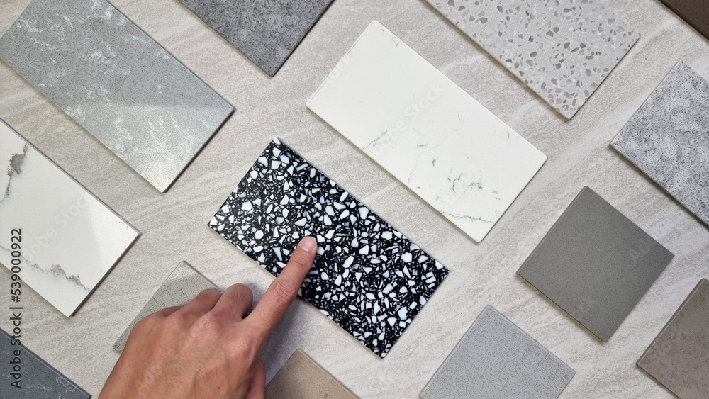 interior designer's hand selecting material samples palette contains ...