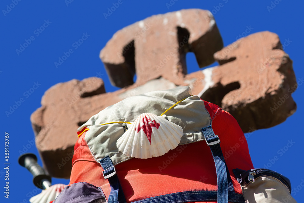 scallop shell on pilgrim backpack on a large cross of the saint on ...