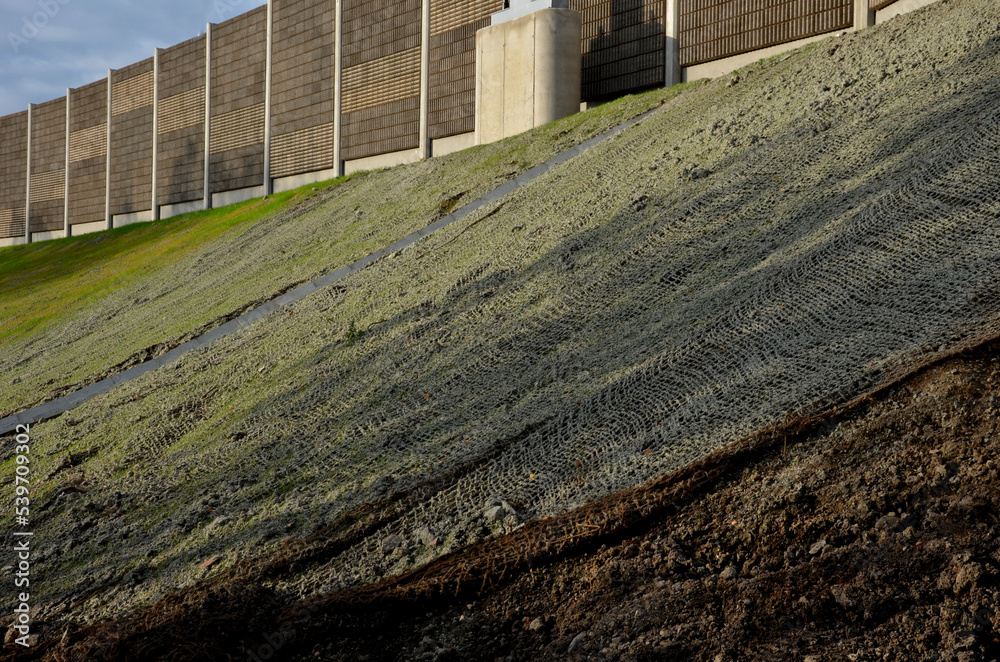 stabilization of slopes by hydro sowing. mixture of wood pulp and green ...