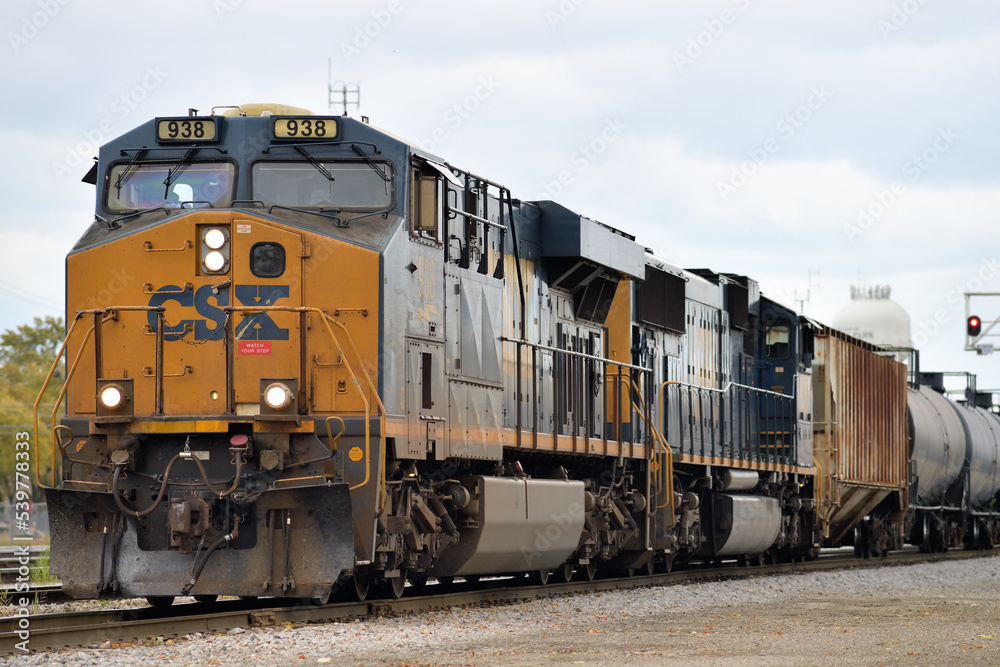 Locomotives lead a freight train toward a Chicago suburban railroad ...