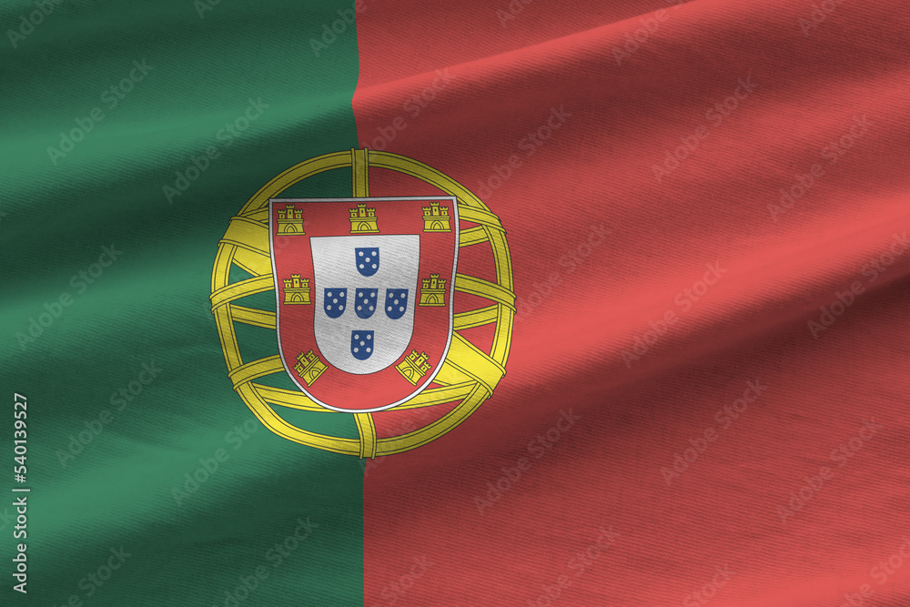 Portugal flag with big folds waving close up under the studio light ...