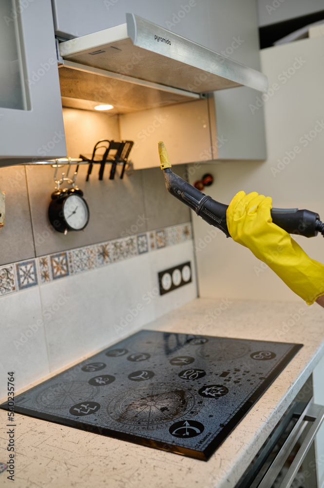 Cleaning the kitchen hood with a steam generator. Cleaning the kitchen ...