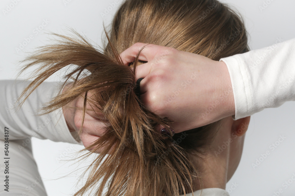 Serie of photos of making a low ponytail with basic elastic hair band ...