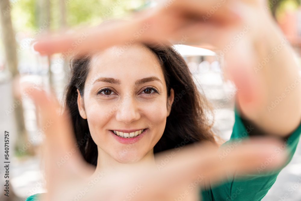 Happy woman making finger frame with hands Stock Photo | Adobe Stock
