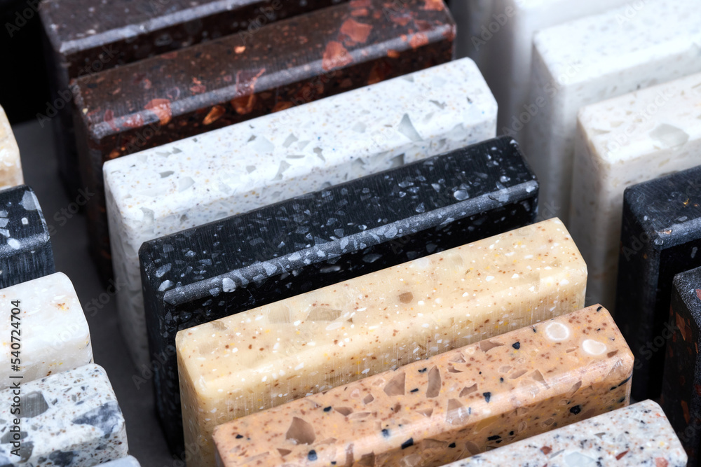 Porcelain stoneware square samples laid on kitchen countertop as ...