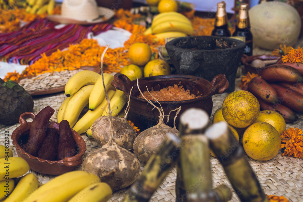 Traditional Mexican Day of the Dead altar with offerings of cempasuchil ...