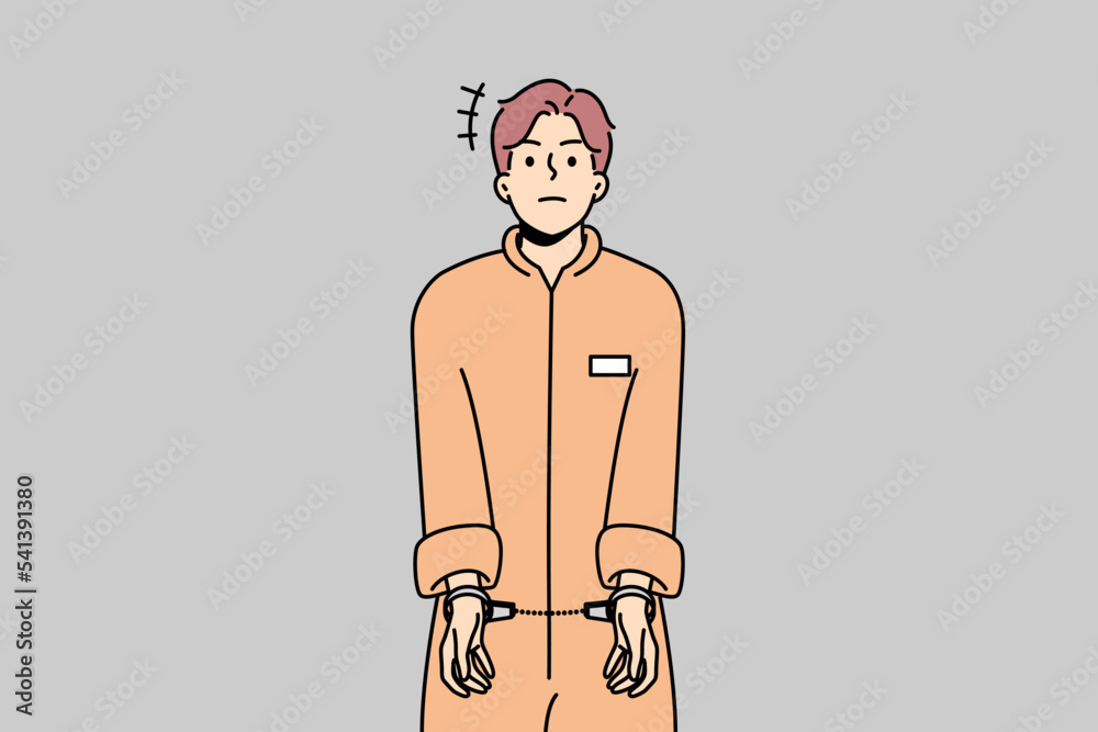 Male prisoner in robe wearing handcuffs. Unhappy man convict in uniform ...