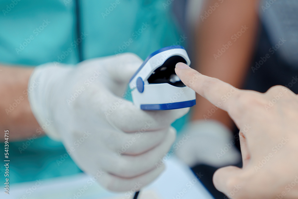 Doctor checking oxygenation with fingertip pulse oximeter. Saturation ...