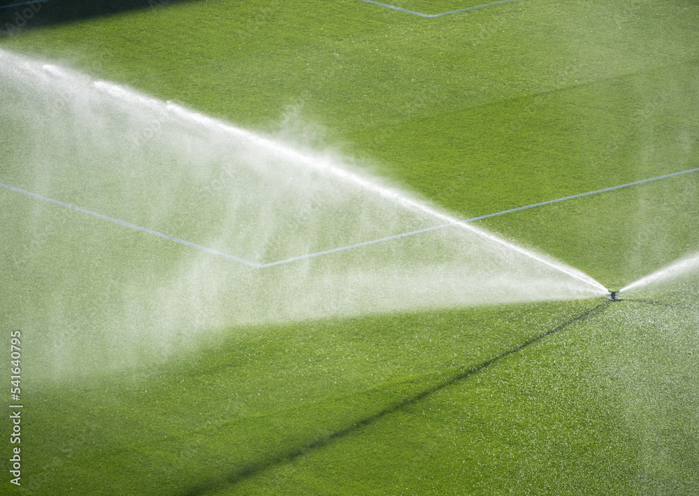 Overhead view of sprinklers watering a football pitch, Spain Stock ...