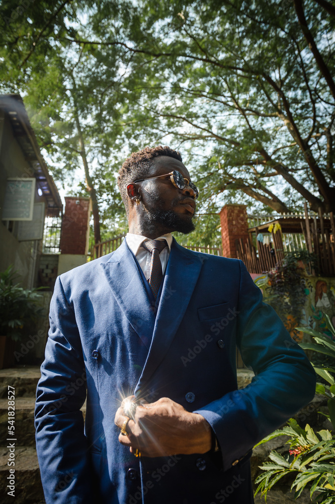 a black man is a short suit posing for portrait in a power pose Stock ...