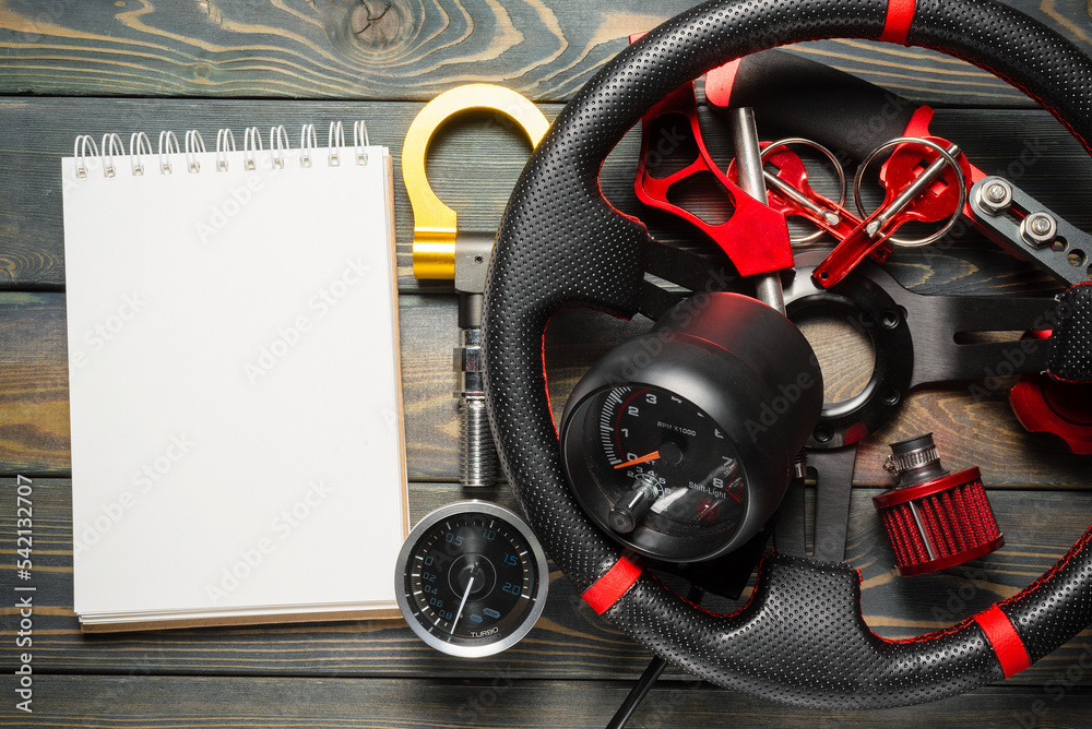 Sport car tuning accessories and blank page notepad on the wooden ...