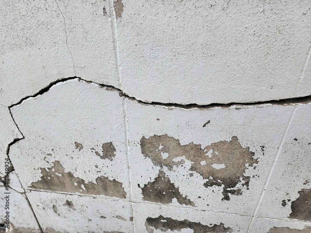 Cracks and peeling of paint in the wall or cement floor are clearly ...