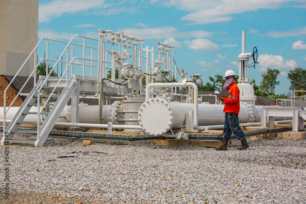 Male worker inspection at steel long pipes and pipe elbow in station ...