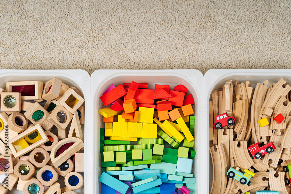 Plastic containers with colorful toy blocks, toy train and wooden ...