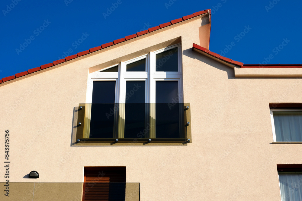 large trapezoid shape windows. glass balustrade on small French balcony ...