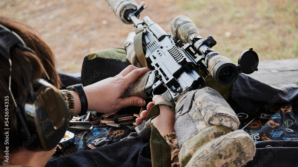 Reloading of a Kalashnikov assault rifle in khaki color of deep ...