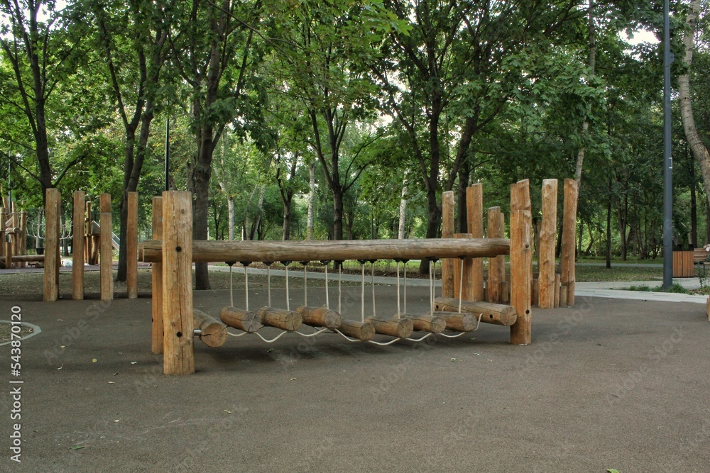 Rope bridge in outdoor modern children wooden playground in a public ...
