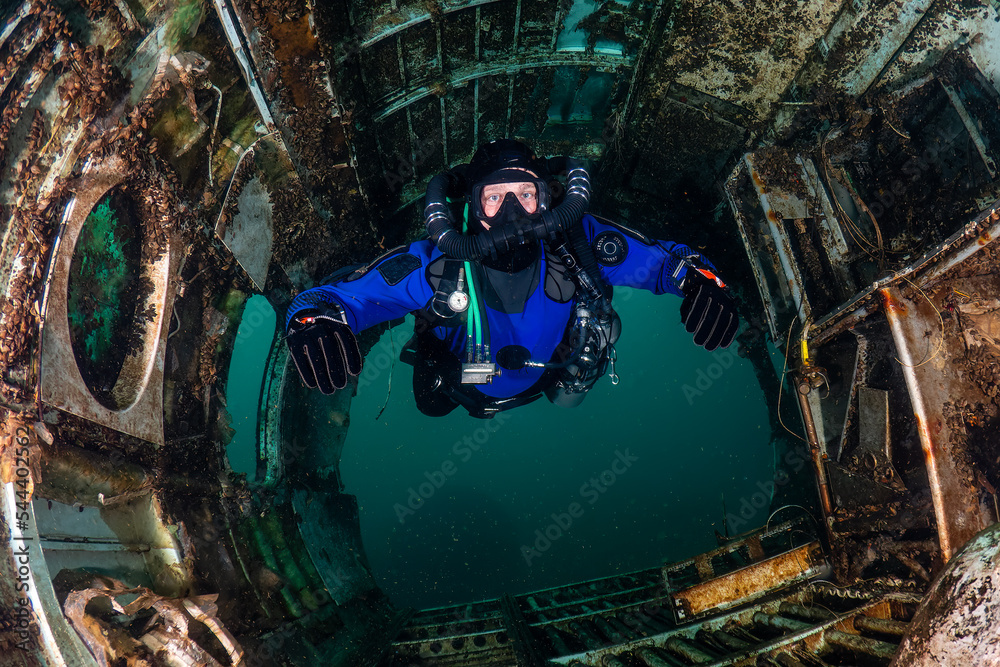 Scuba Diver on a closed circuit rebreather swimming through the ...
