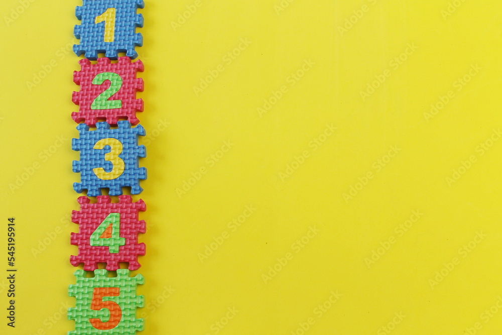soft puzzles with numbers on a yellow background, colorful numbers one ...