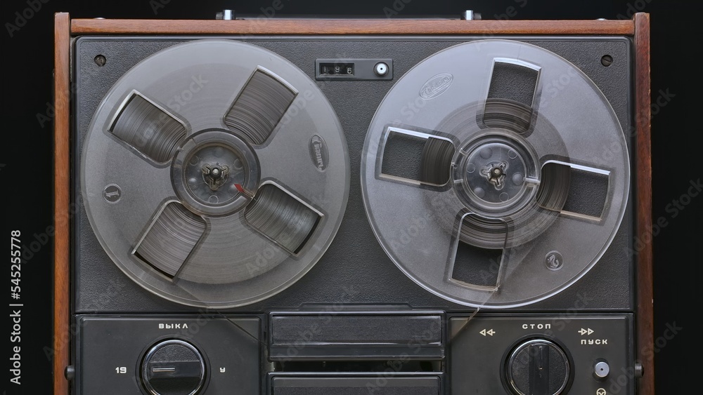 Vintage reel to reel tape recorder on black studio background. Retro ...