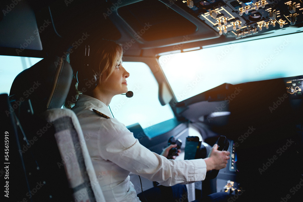 Woman pilot in the cockpit Stock Photo | Adobe Stock