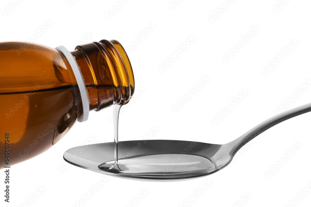 Pouring syrup into spoon from bottle isolated on white, closeup. Cough ...
