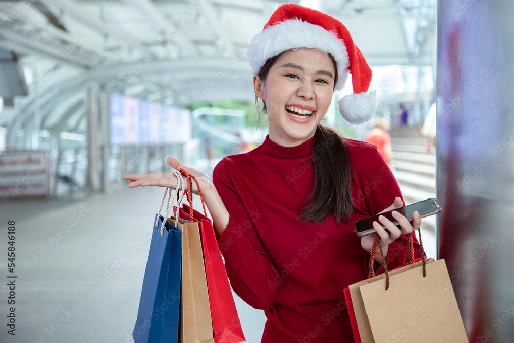 Beautiful Asian woman shows an ecstatic expression after shopping mall ...